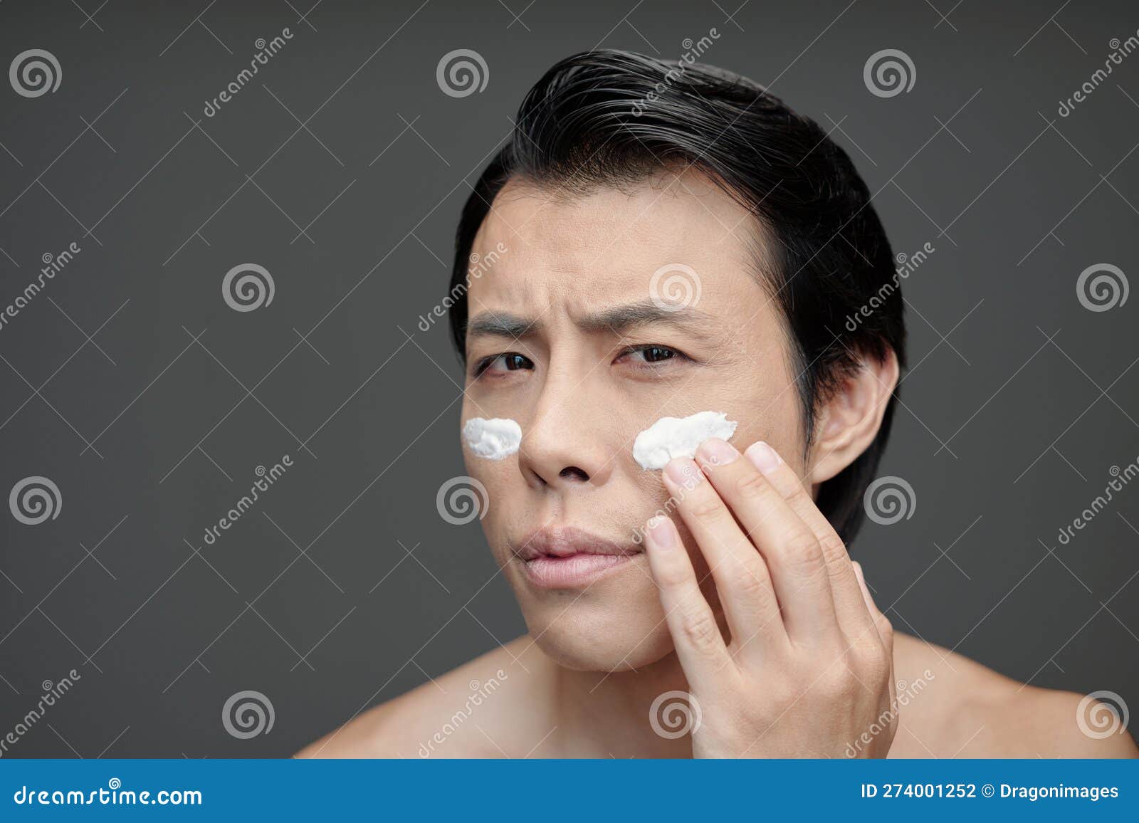 Frowning Man Applying Moisturizer Stock Photo - Image of imperfection ...