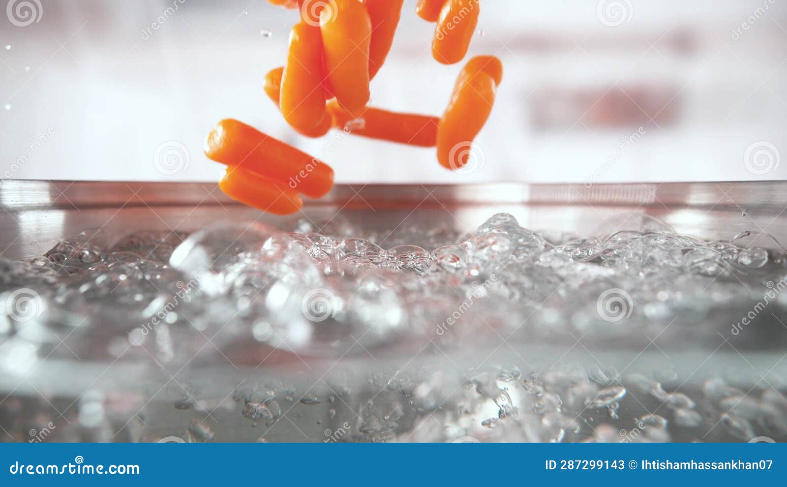Frozen Baby Carrots Falling into Pot with Boiling Water in Macro ...