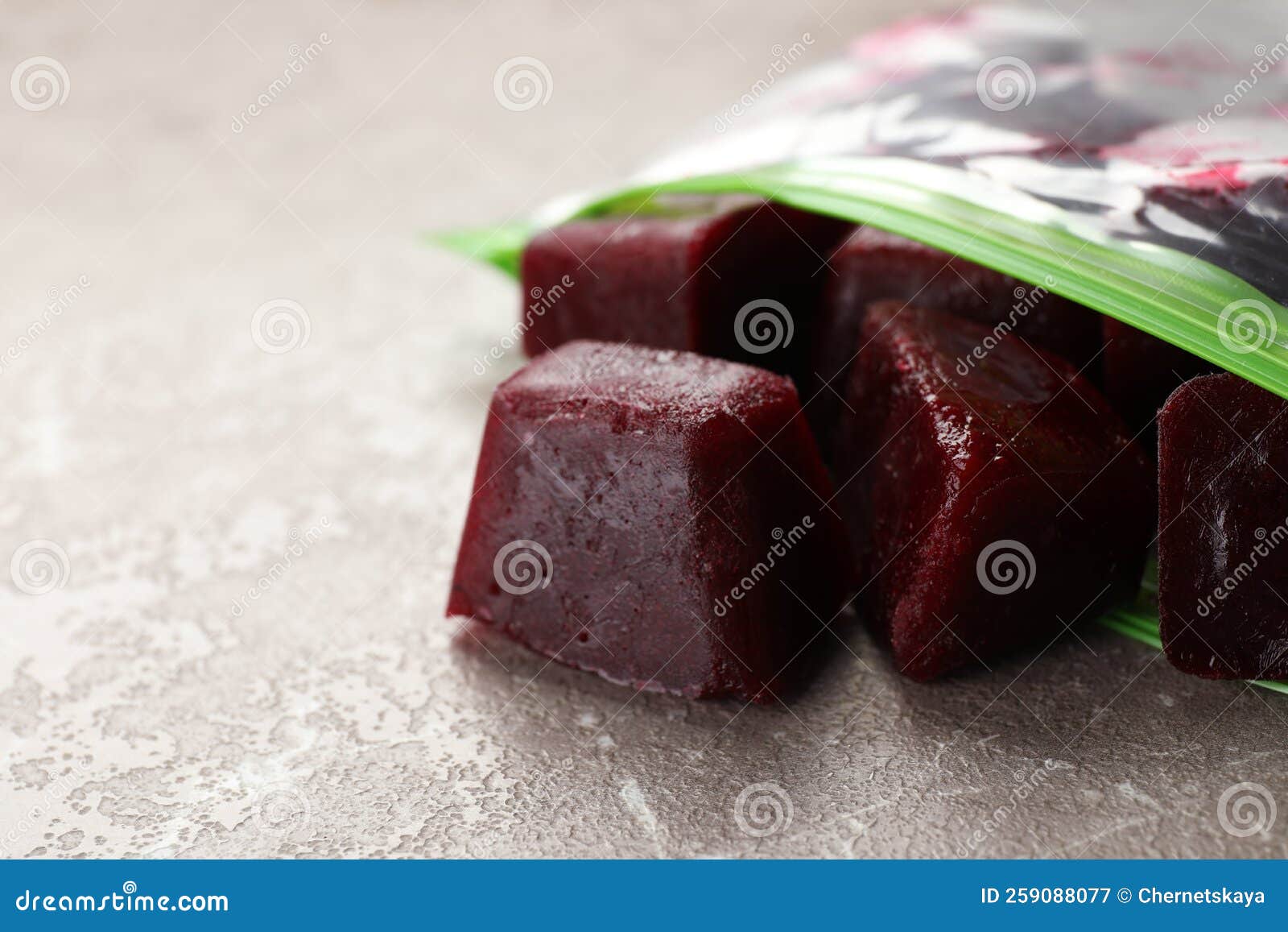Frozen Beet Puree Cubes in Plastic Bag on Marble Table, Closeup. Space ...