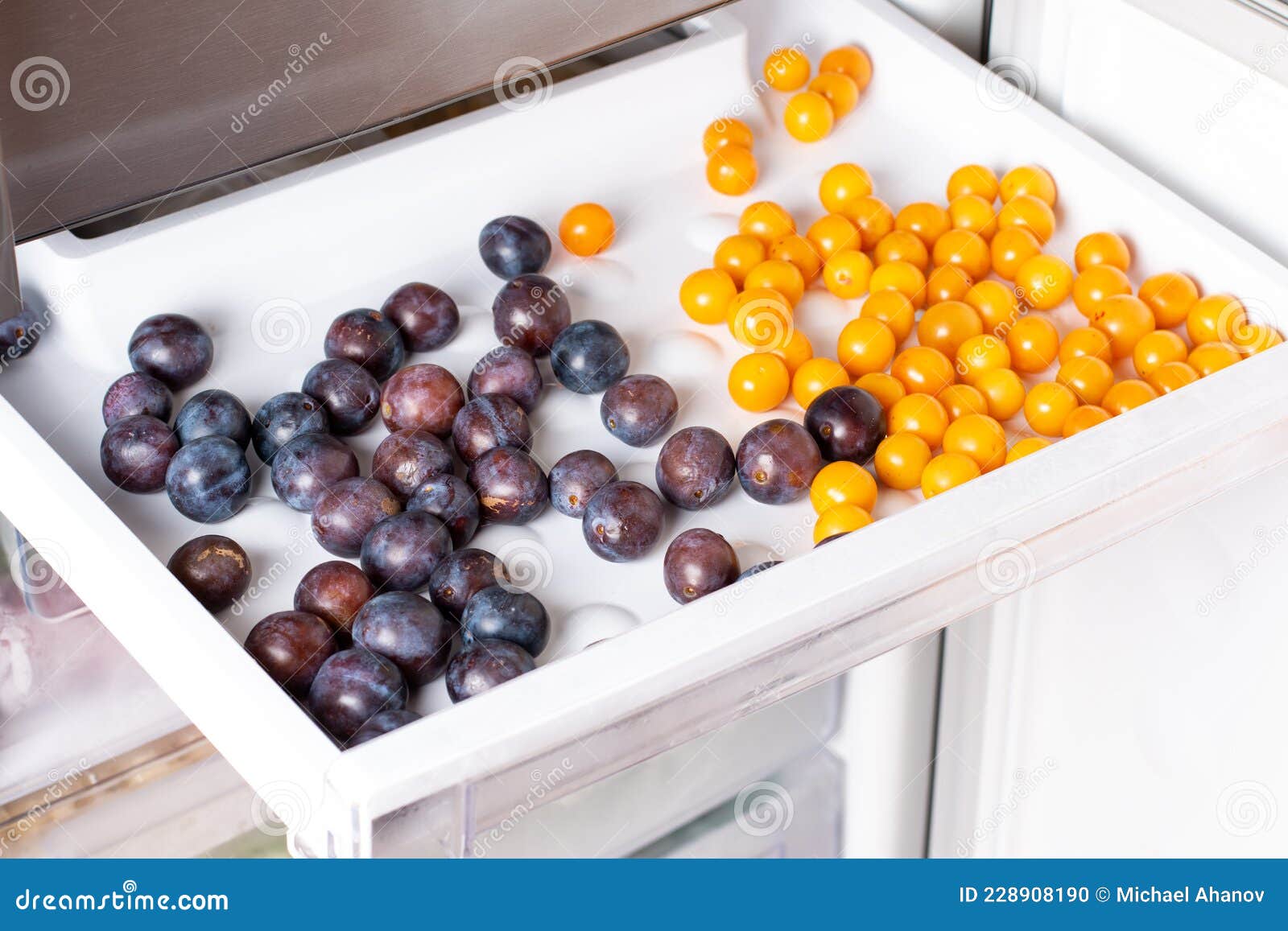 Frozen Berries in the Freezer. Frozen Plums, Cherry Plums on the ...