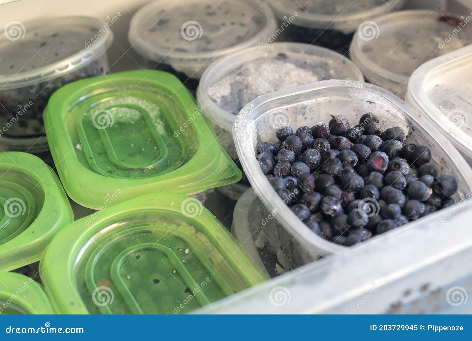 Frozen Blueberries in the Fridge Packed in Plastic Boxes. Stock Image ...