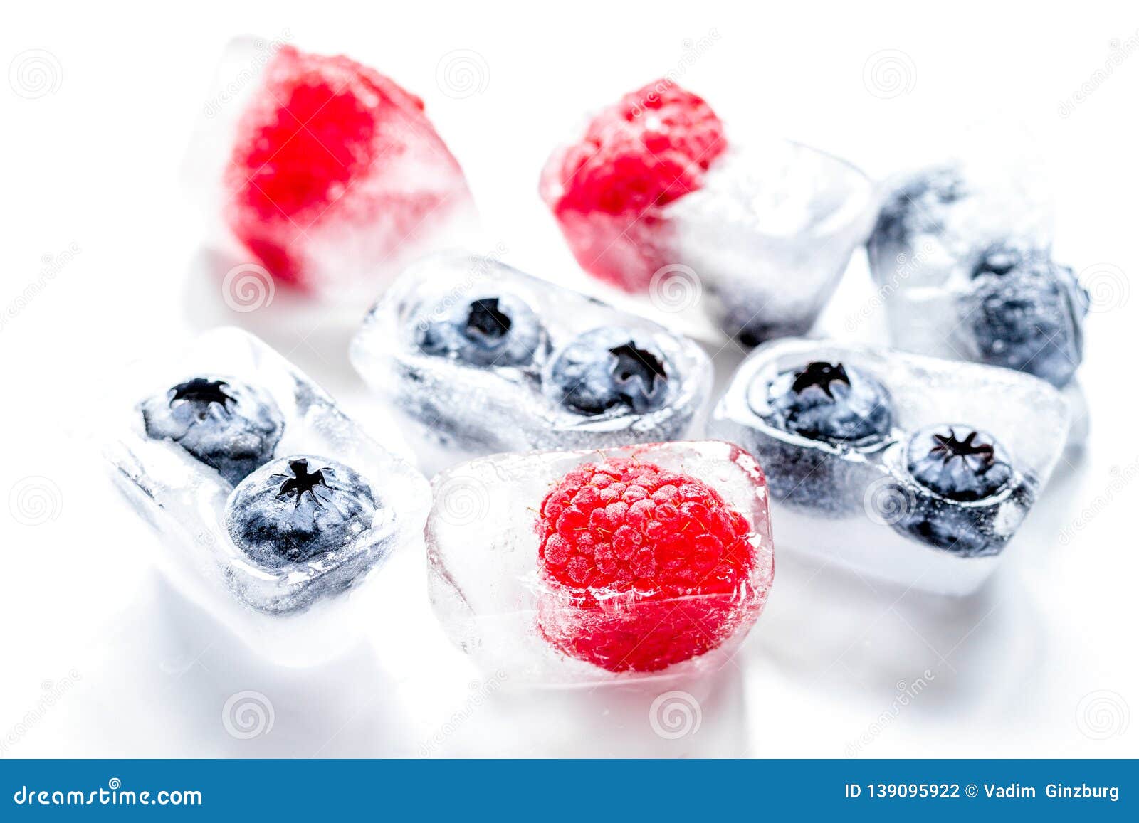 Frozen Blueberry and Raspberry in Ice Cubes on White Background Stock ...
