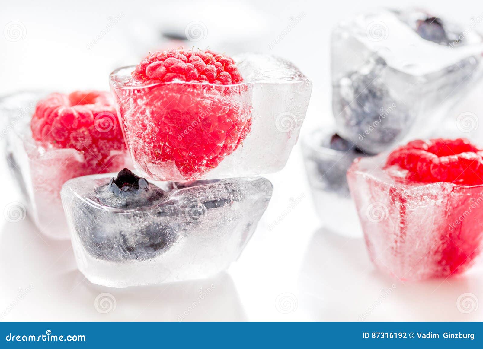 Frozen Blueberry and Raspberry in Ice Cubes on White Background Stock ...