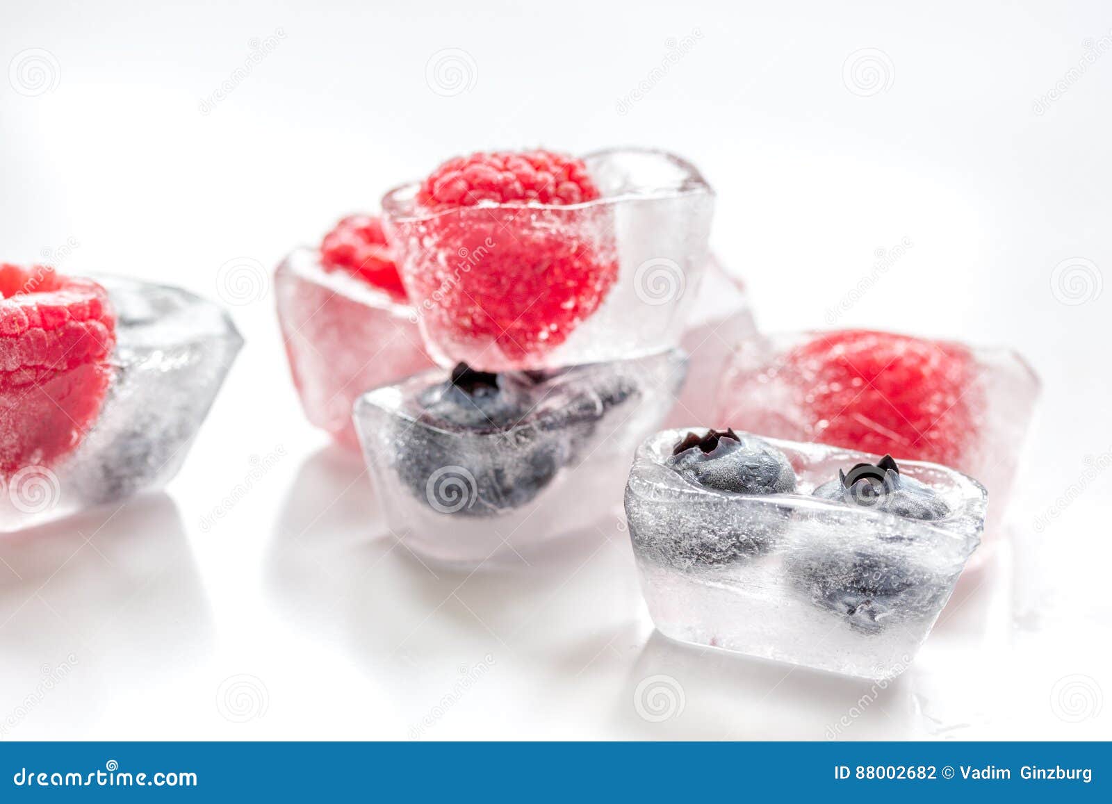 Frozen Blueberry and Raspberry in Ice Cubes on White Background Stock ...