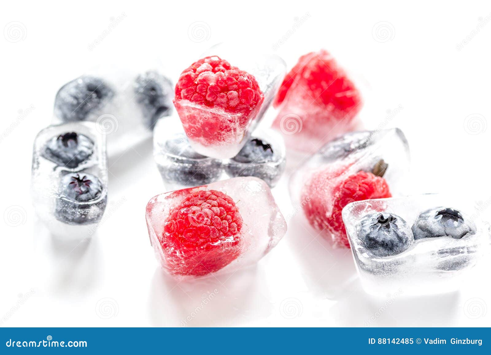 Frozen Blueberry and Raspberry in Ice Cubes on White Background Stock ...