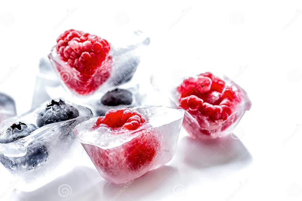 Frozen Blueberry and Raspberry in Icecubes on White Background Stock ...