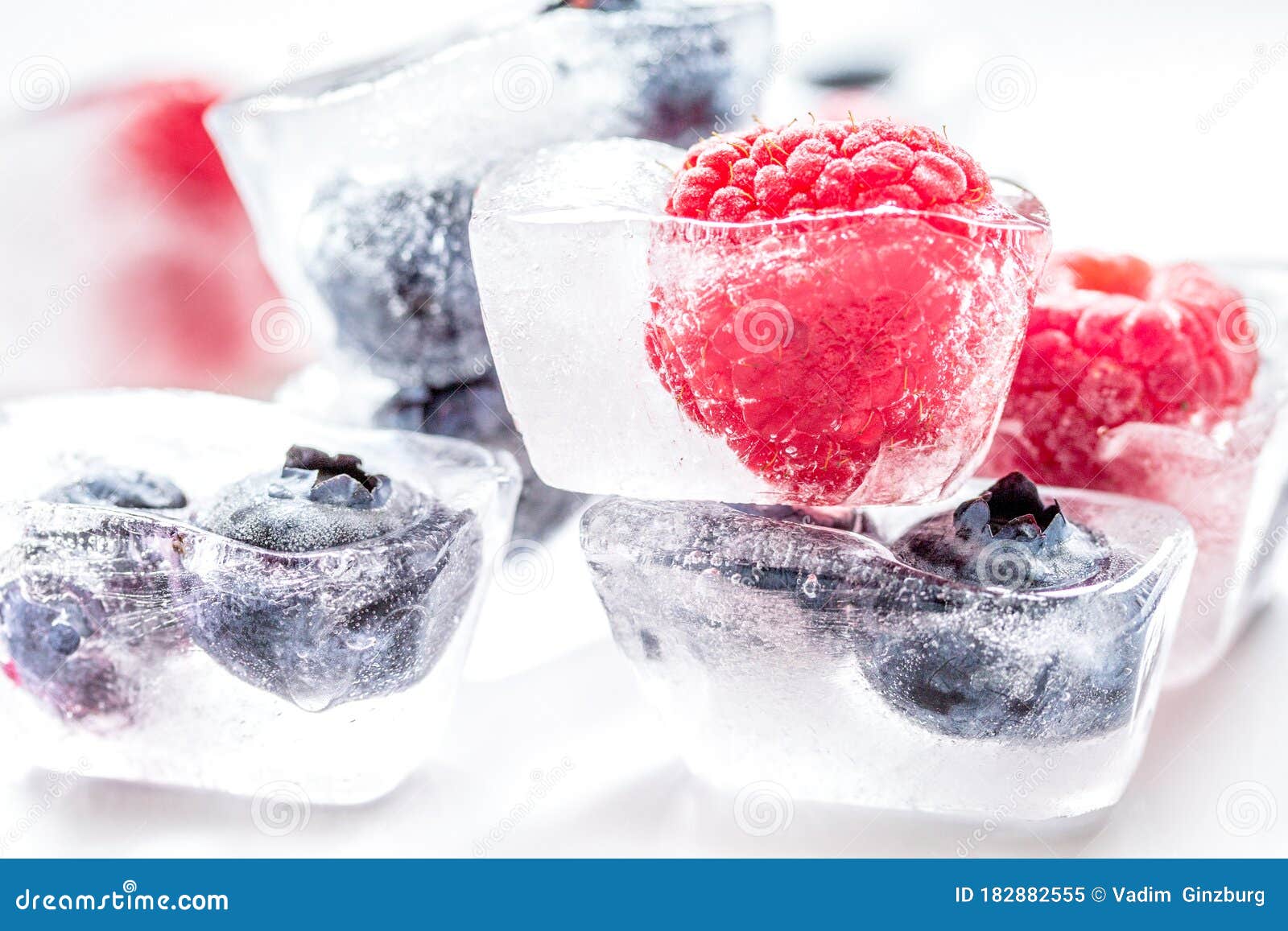 Frozen Blueberry and Raspberry in Icecubes on White Background Stock ...