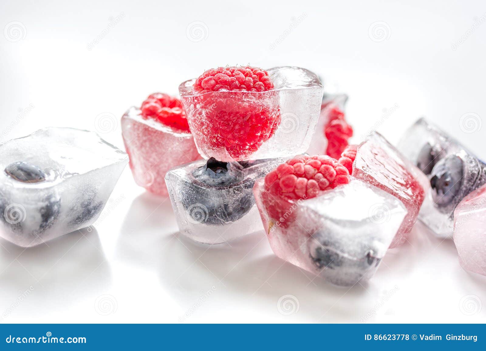 Frozen Blueberry and Raspberry in Icecubes on White Background Stock ...