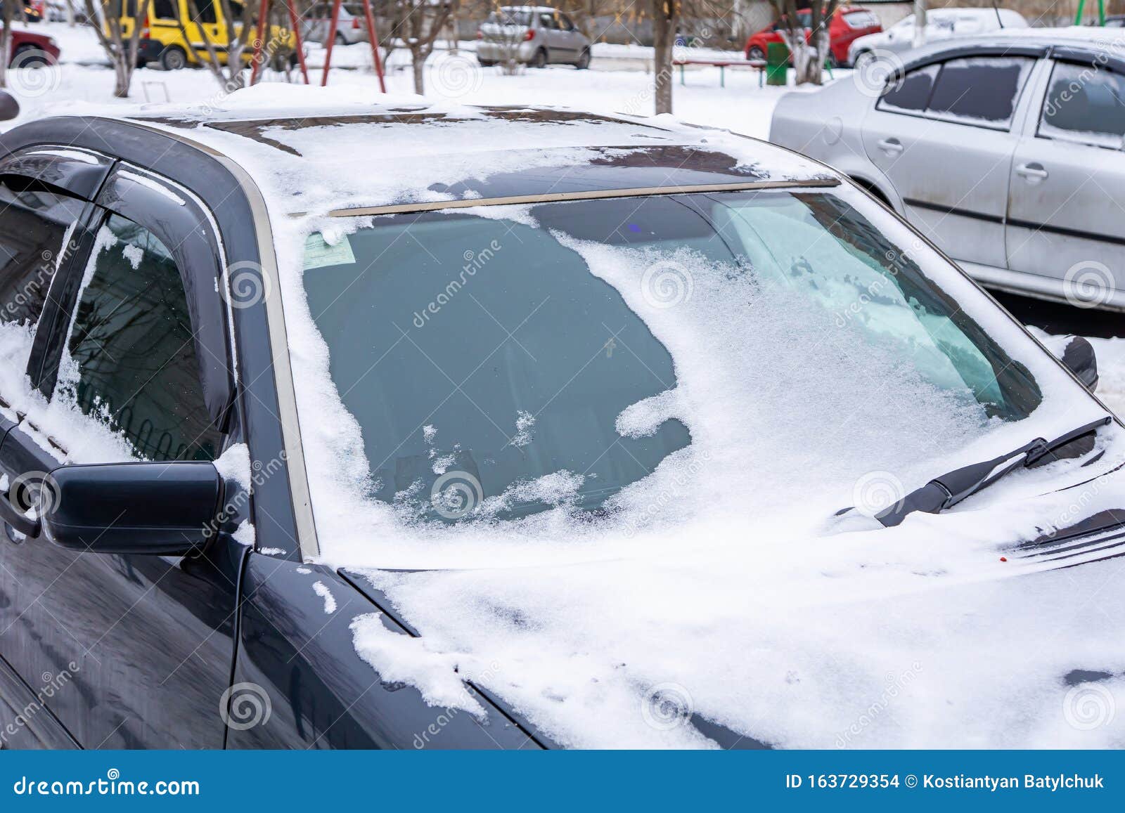 A Frozen Car Windshield is Covered in Ice and Snow on a Winter Day ...