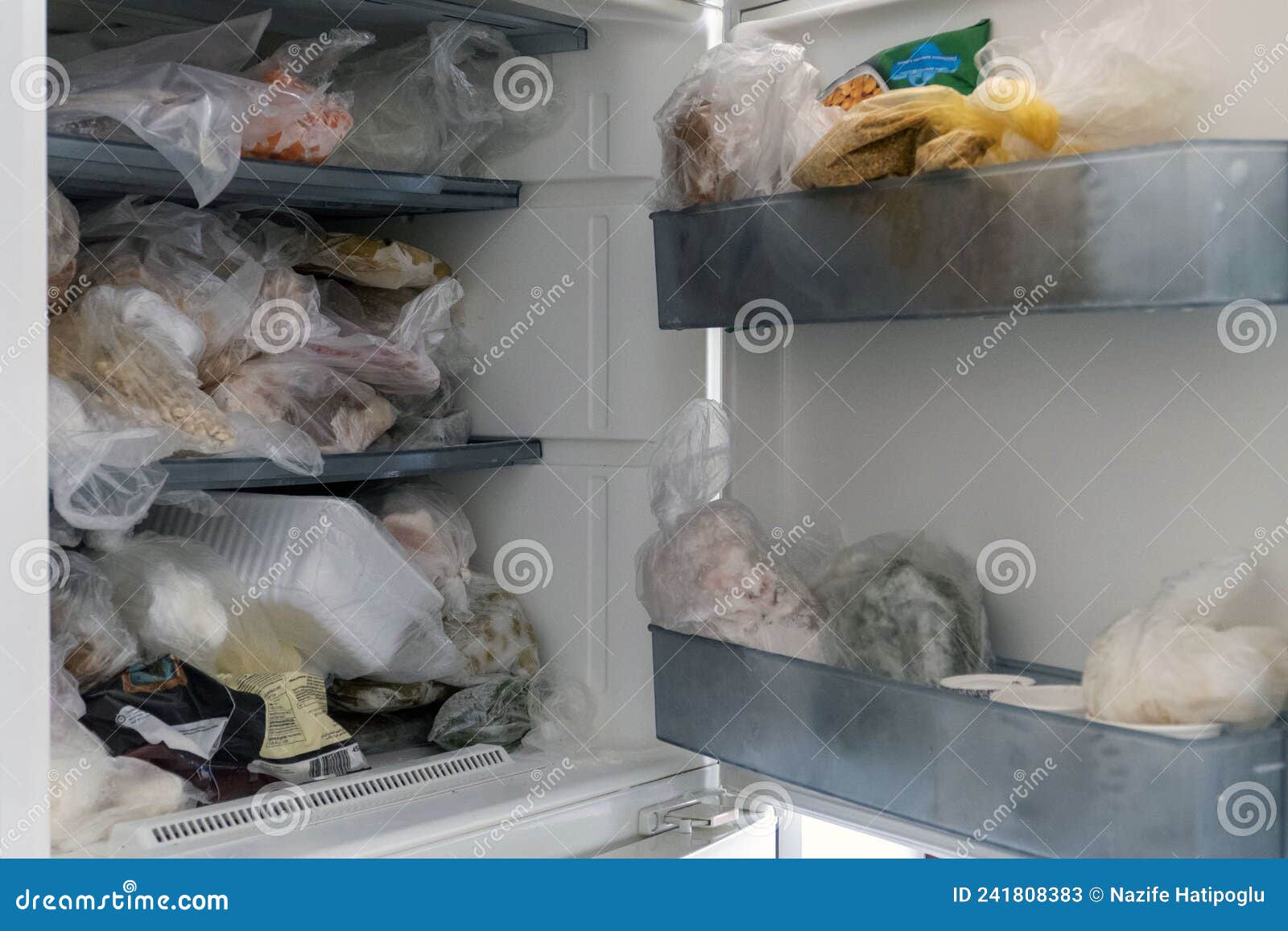 Frozen Foods are in a Freezer with the Door Open, a Messy Inside of a ...