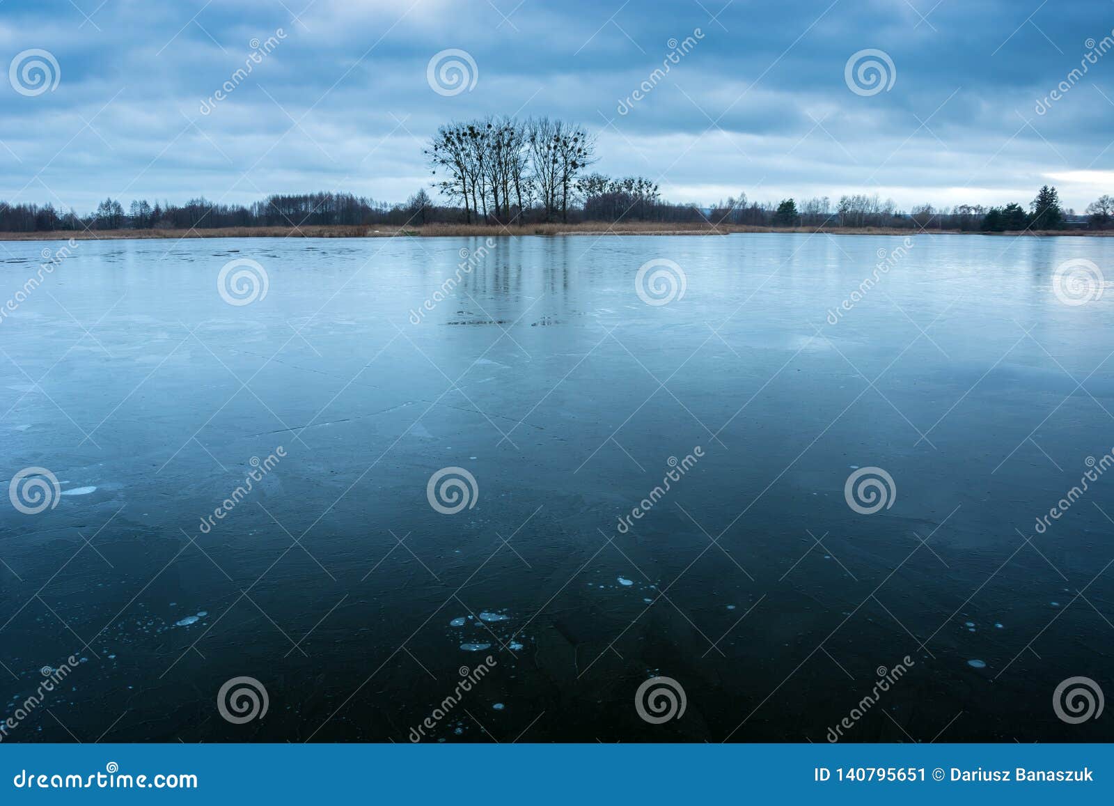Frozen Lake, Trees on the Shore and Clouds in the Sky Stock Image ...