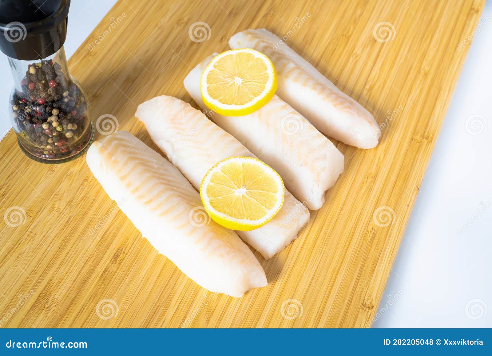 Frozen Pieces of Cod Fish Fillets or Loins with Slices of Lemon on ...
