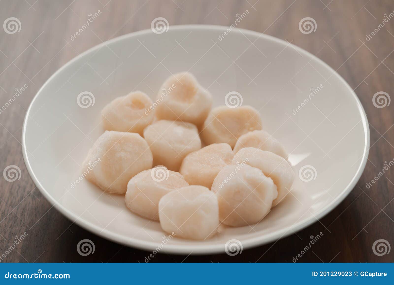 Frozen Scallops in White Bowl on Walnut Table for Defrosting Stock ...