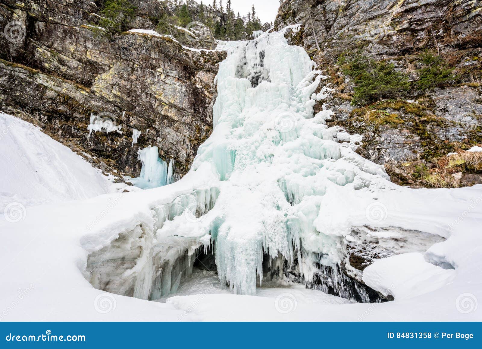 Frozen Waterfall on Bare Mountain with Deep Snow on the Ground. Stock ...