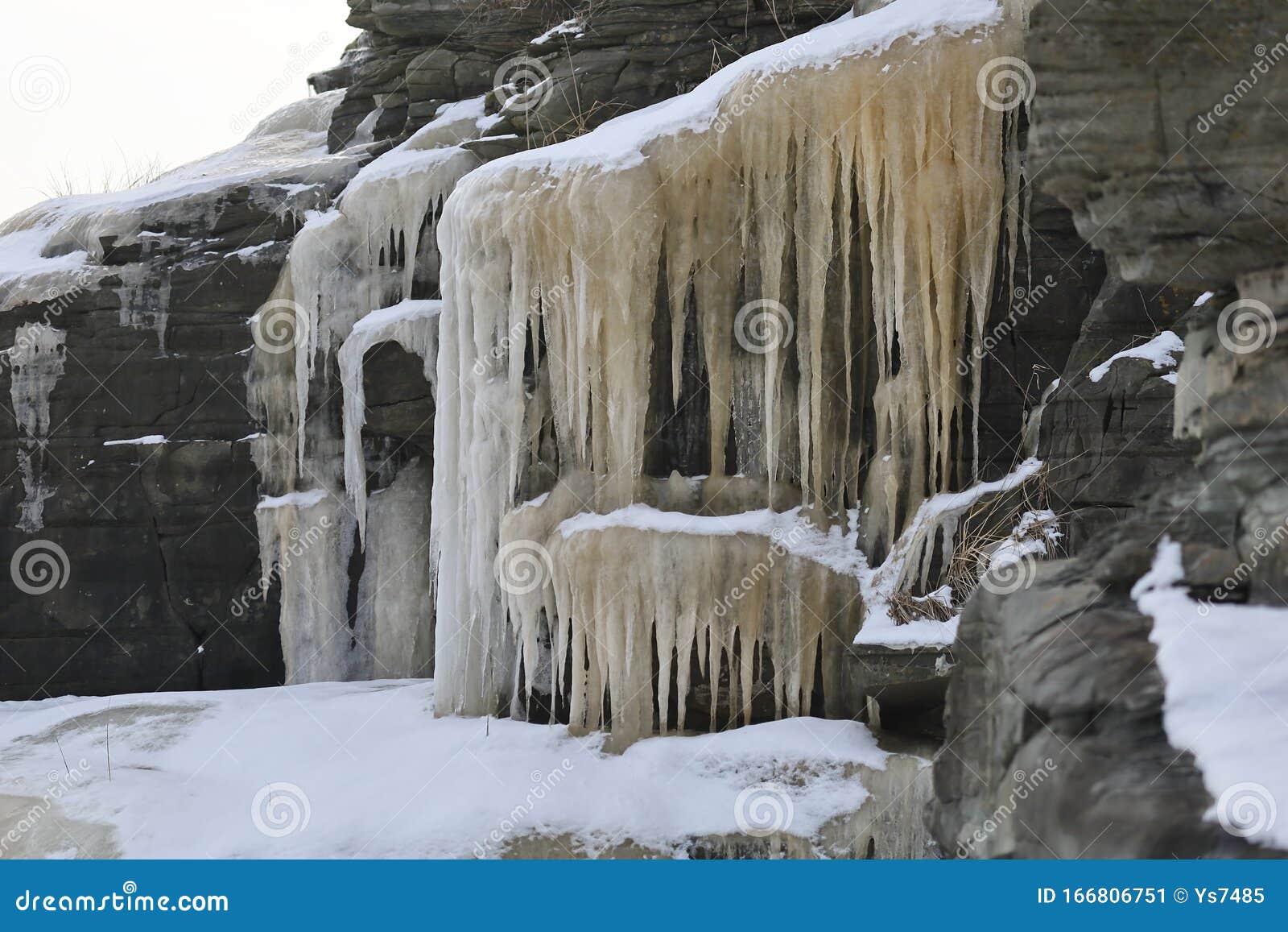 Frozen Waterfall in Gray Rocks. Icicles and Snow in Winter Cold ...