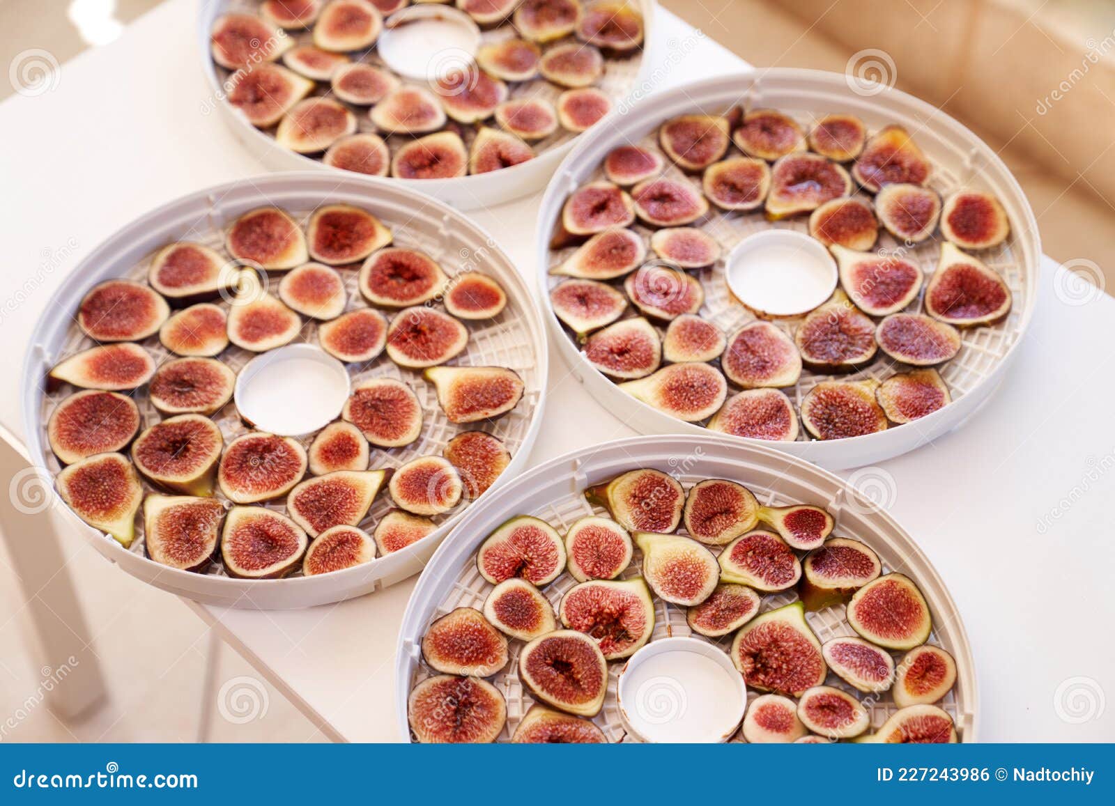 Fruit Drying Process on White Dehydrator Plates on Balcony Table Stock ...