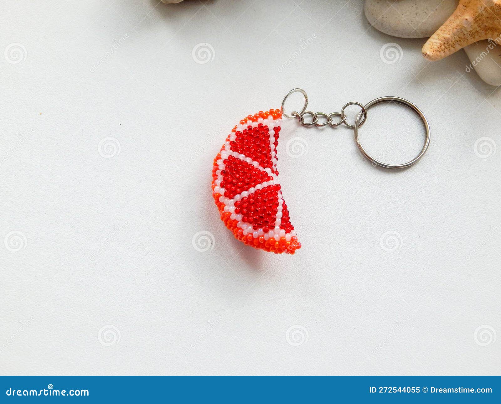 Fruit key chain and pebble stock image. Image of deco - 272544055