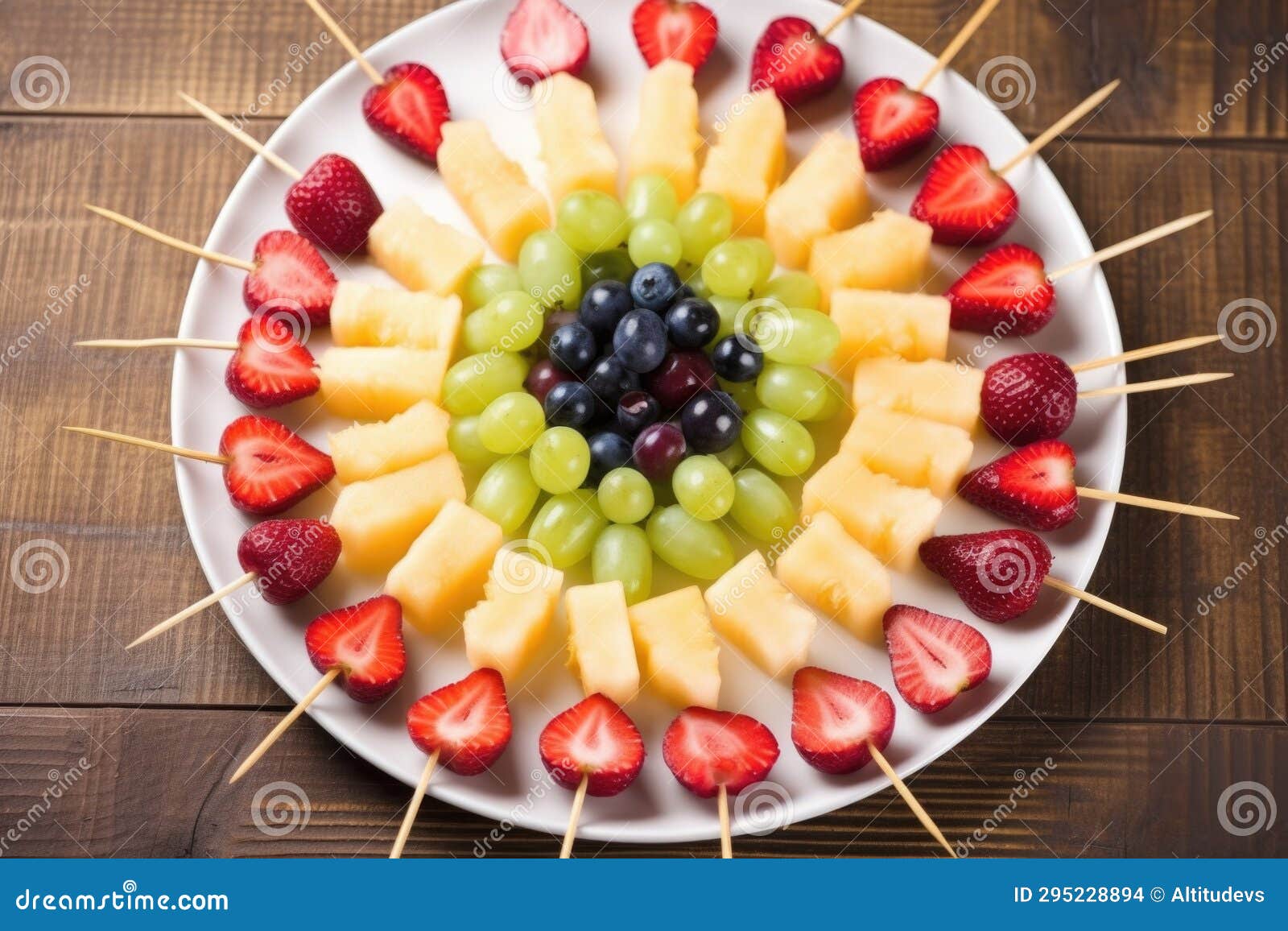 Fruit Skewers Arranged in a Circular Pattern on a Plate Stock Photo ...