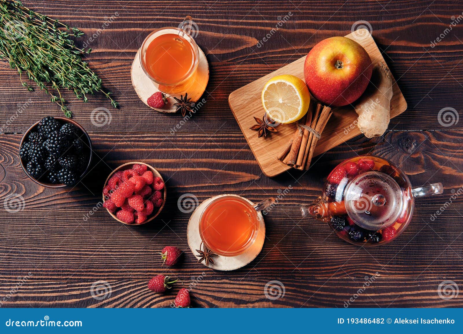 Fruit Tea with Raspberries, Bramble, Apple and Lemon in Cups and Teapot ...