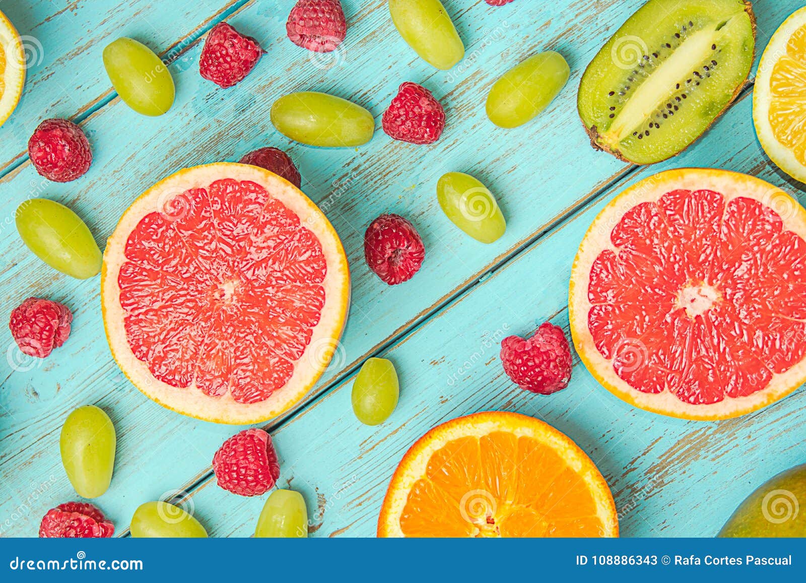 Fruits on a Light Blue Rustic Table. Grapefruit, Grapes,blackberries ...