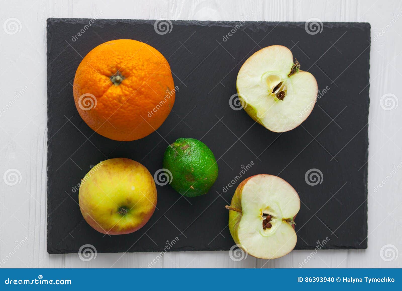 Fruits. Orange, Lime, Apple, Avocado on Black Stone Stock Photo - Image ...