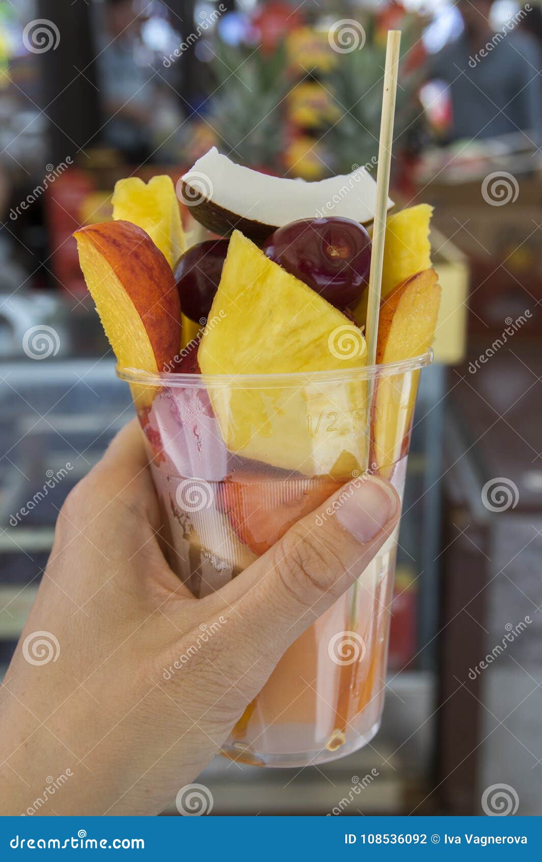 Fruity Summer Refreshment in a Plastic Cup Kept by Hand, Pieces of ...