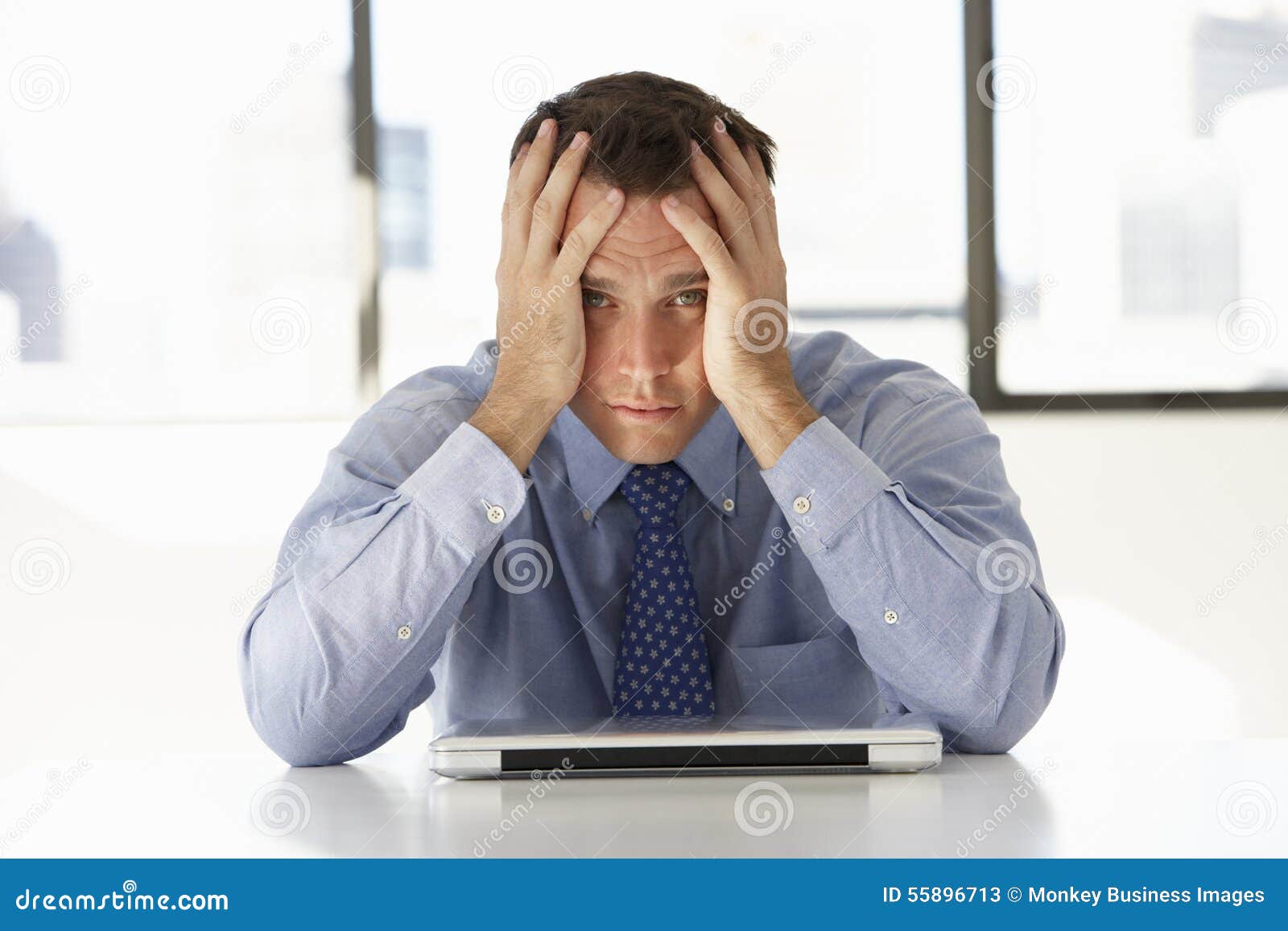 Frustrated Businessman Sitting at Desk in Office Using Laptop Stock ...