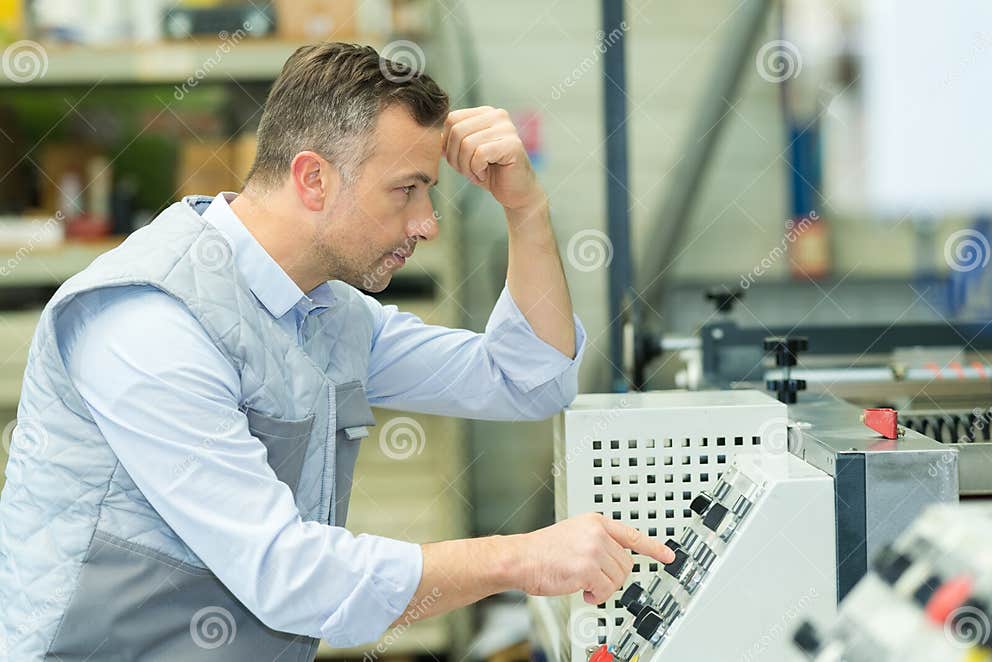 Frustrated Engineer Working on Machiner in Factory Stock Image - Image ...