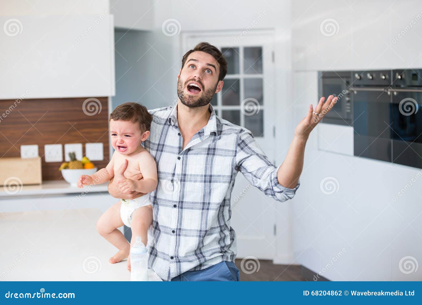 Frustrated Father Holding Crying Baby Boy in Kitchen Stock Photo ...