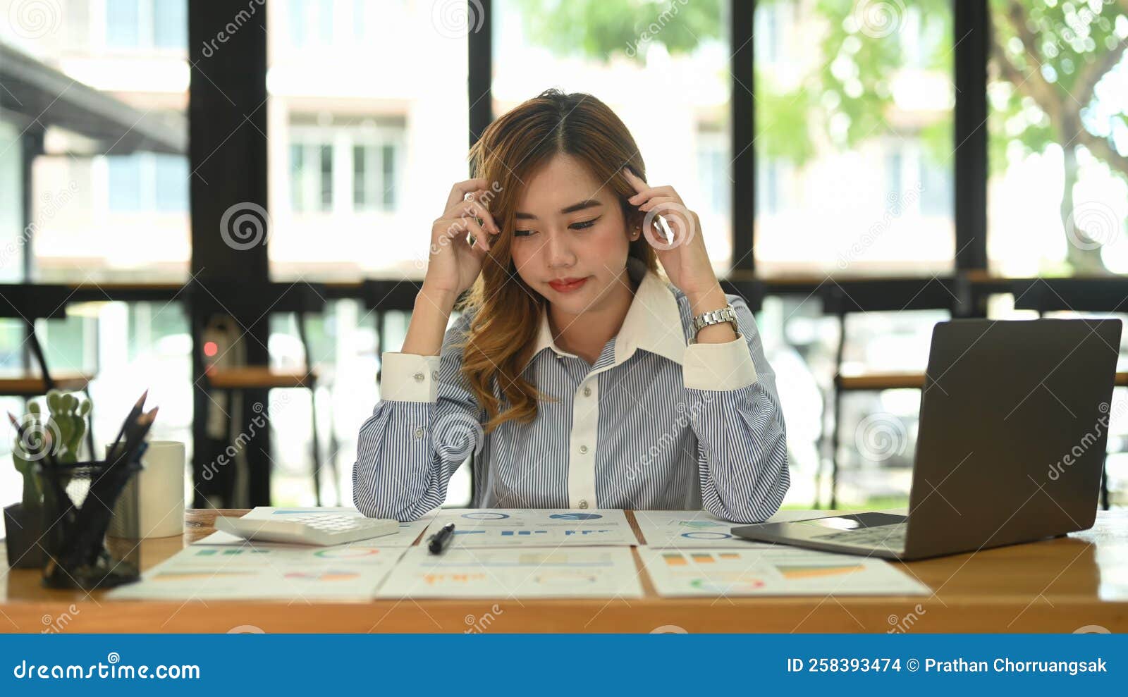 Frustrated Female Worker Holding Her Head and Looking at Financial ...