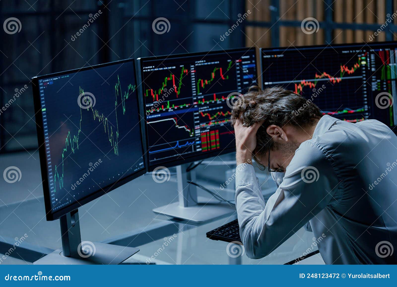 Frustrated Investor Sitting in Front of the Working Monitors of His ...