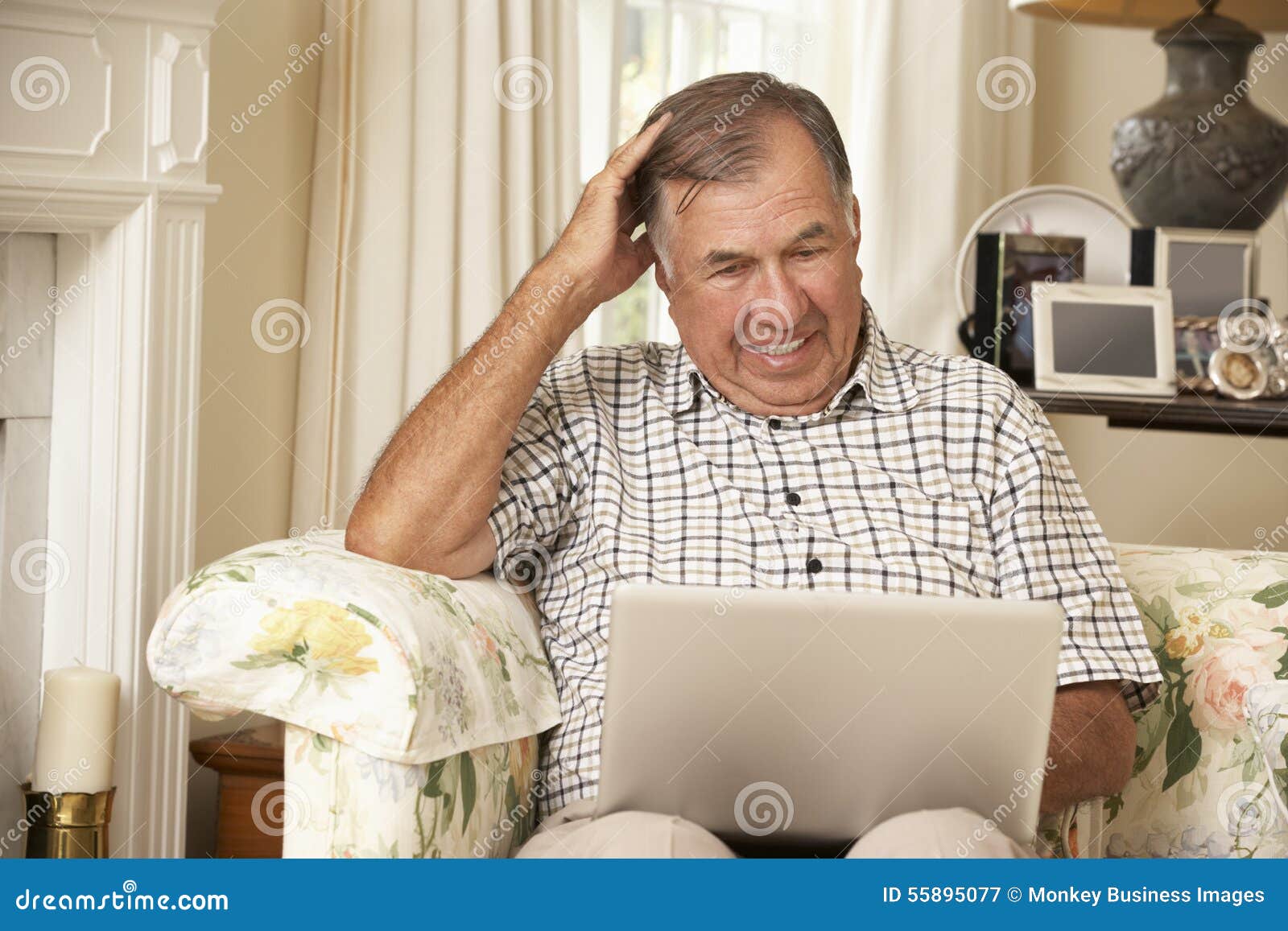 Frustrated Retired Senior Man Sitting on Sofa at Home Using Laptop ...