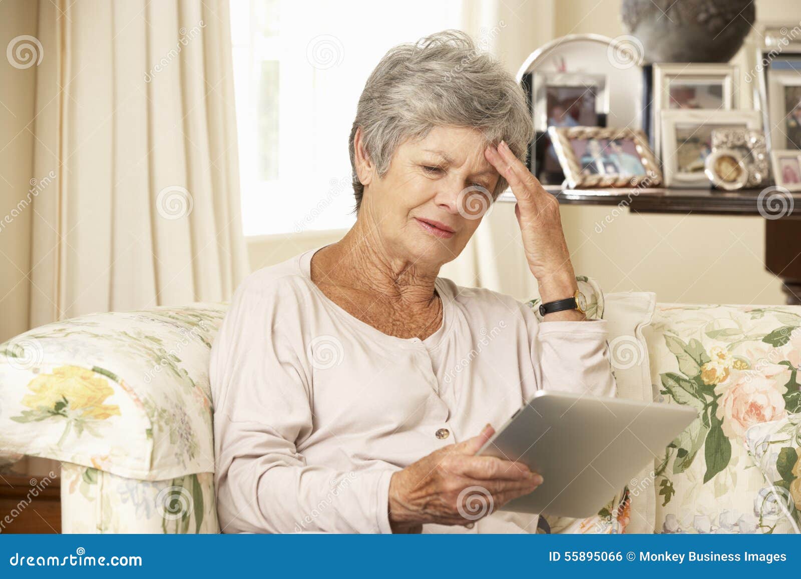 Frustrated Retired Senior Woman Sitting on Sofa at Home Using Digital ...