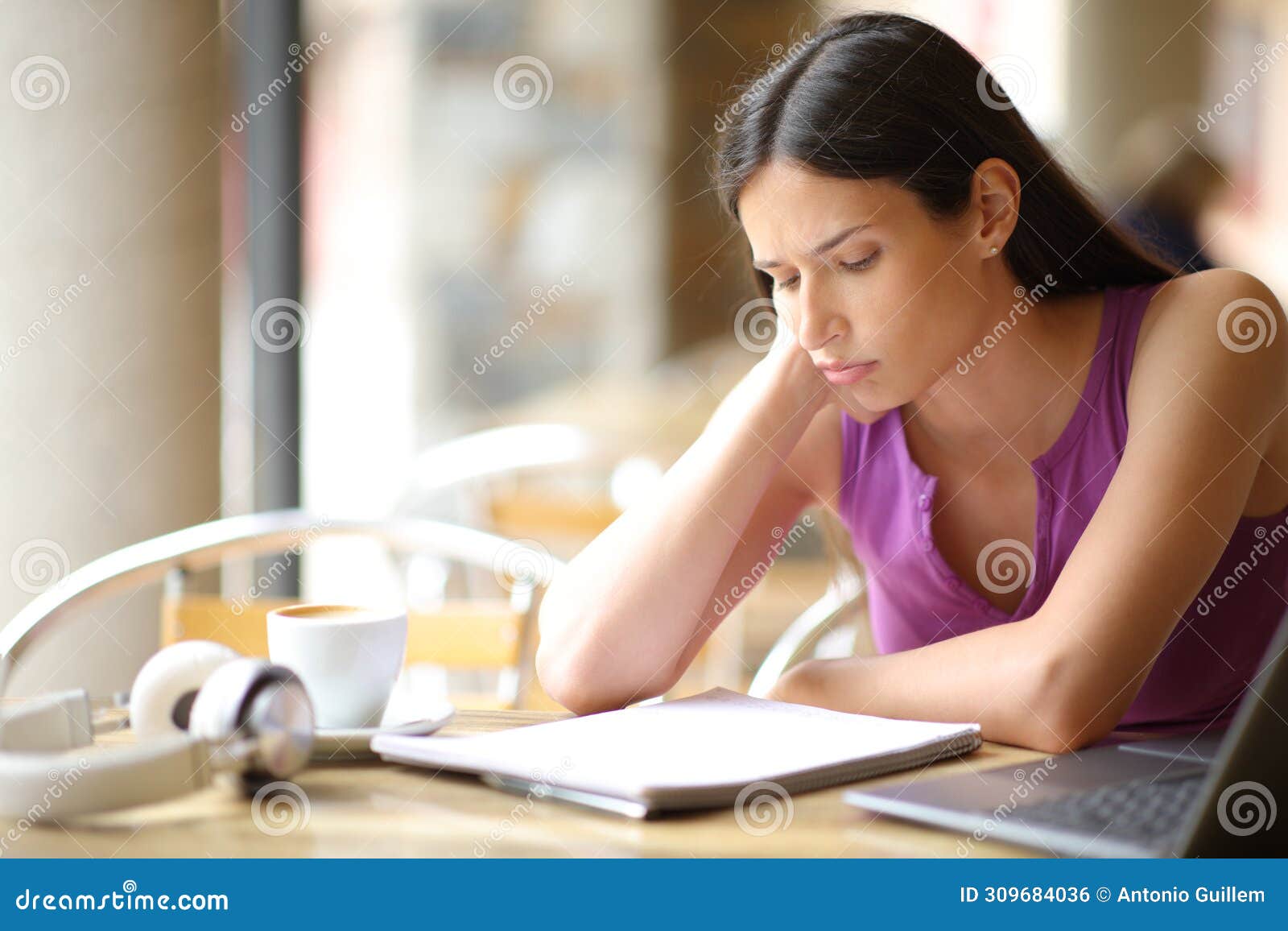Frustrated Student in a Bar Reading Notes Stock Photo - Image of laptop ...