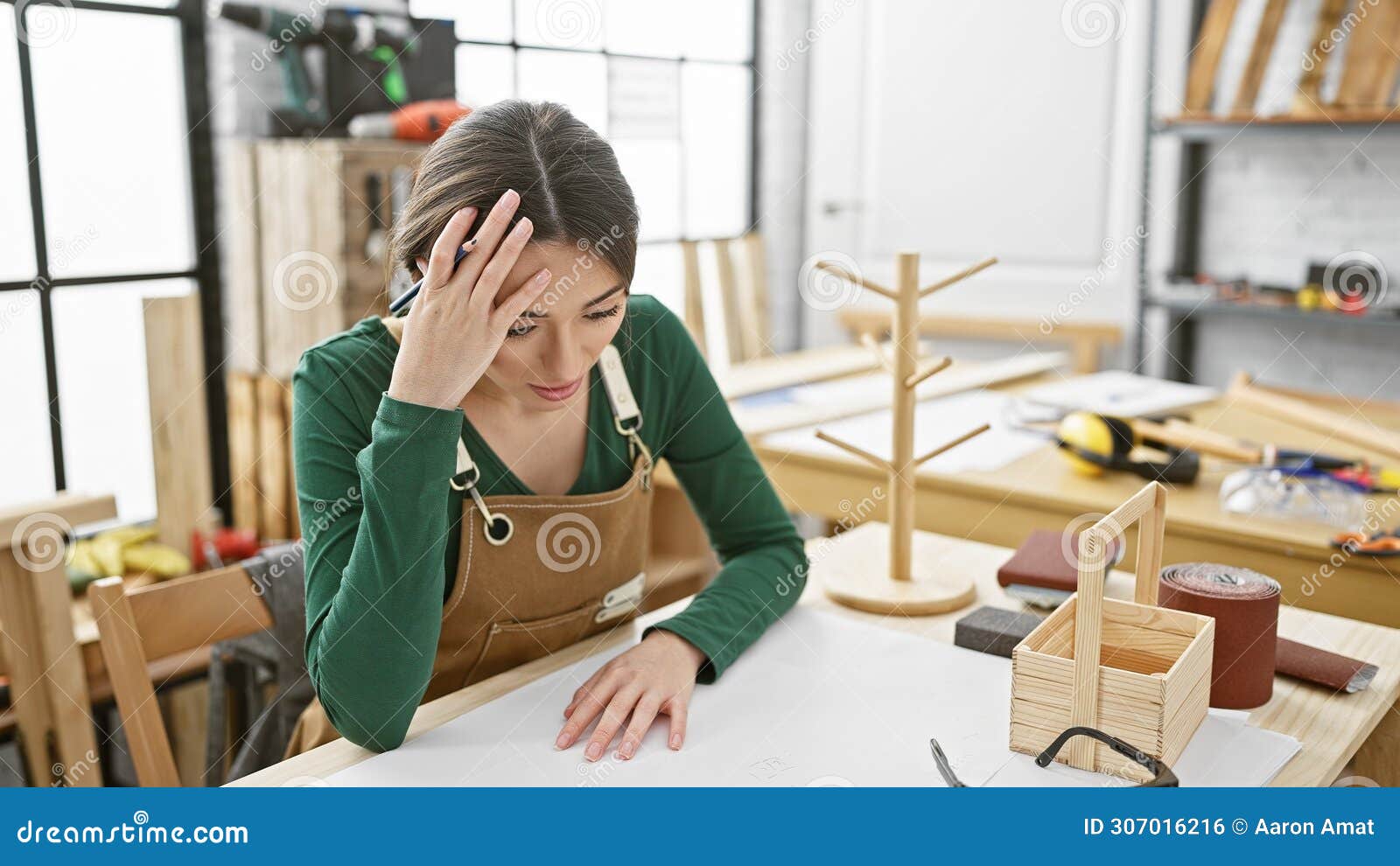 A Frustrated Woman Artisan in a Workshop with Tools and Wooden Objects ...