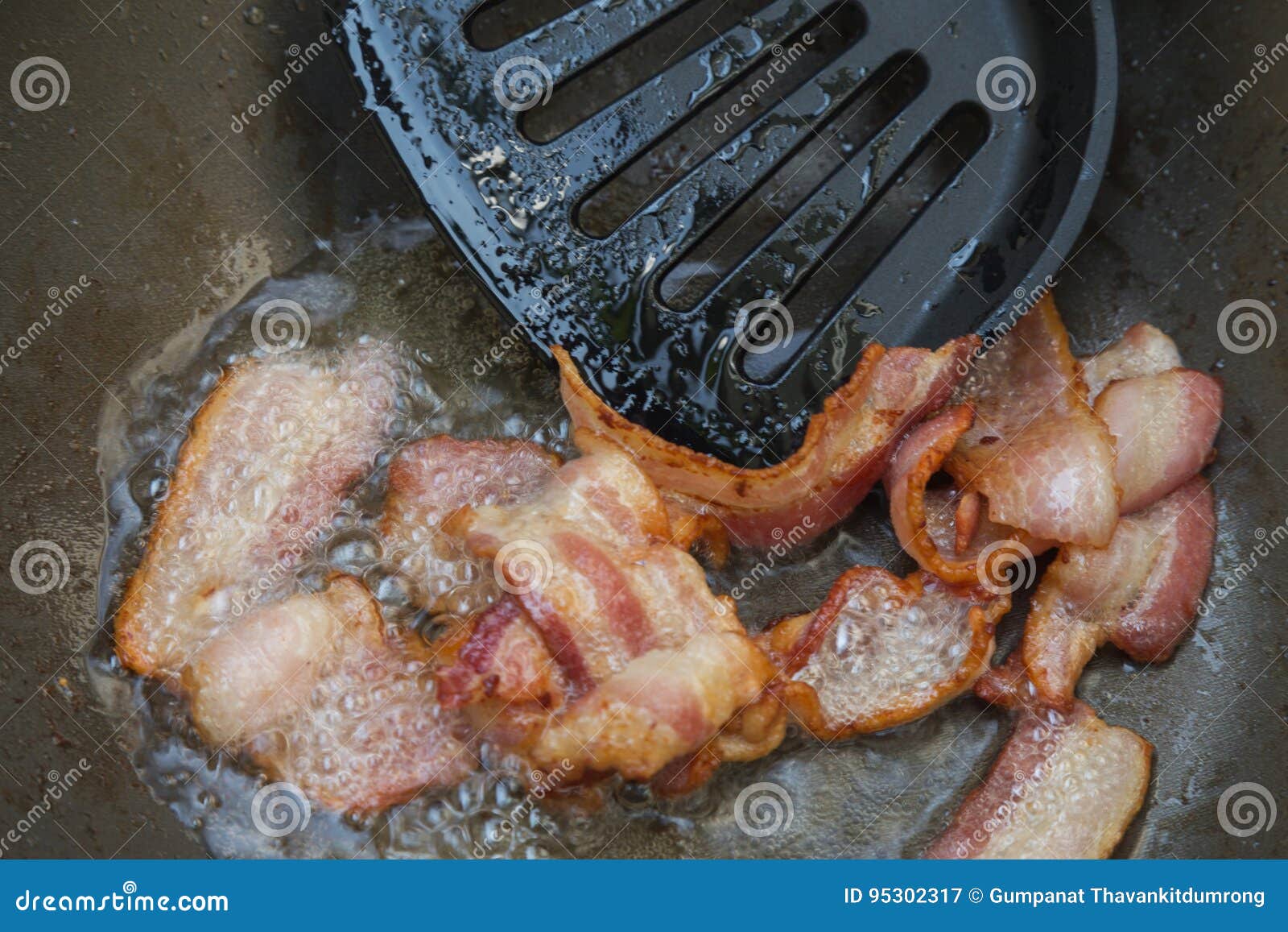 Frying bacon in the pan. stock image. Image of strips - 95302317