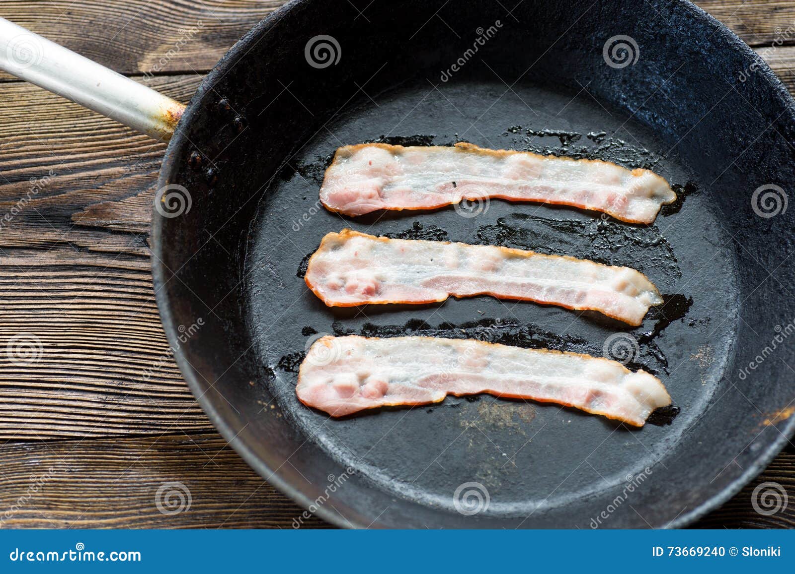Frying bacon in the pan stock photo. Image of iron, sliced - 73669240