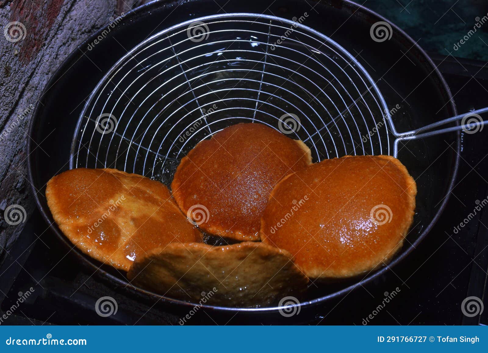 Frying Chapati(poori) with Spoon on Frying Pan, Boiling Oil in Frying ...