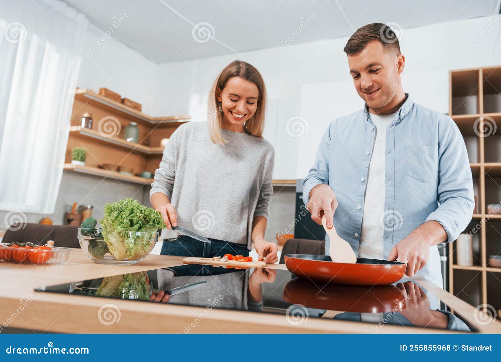 Frying Food in a Pan. Couple Preparing Food at Home on the Modern ...