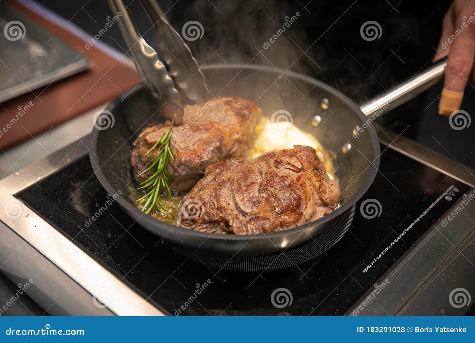 Frying meat on frying pans stock photo. Image of roasted - 183291028
