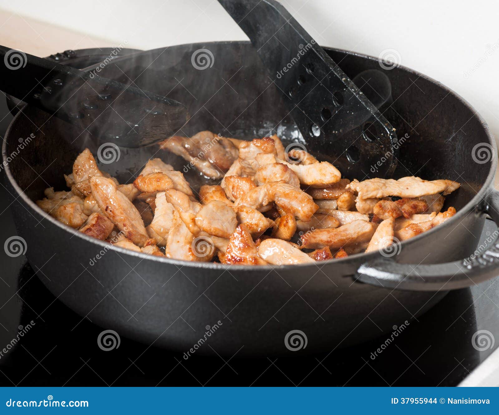 Frying meet in skillet stock photo. Image of service - 37955944