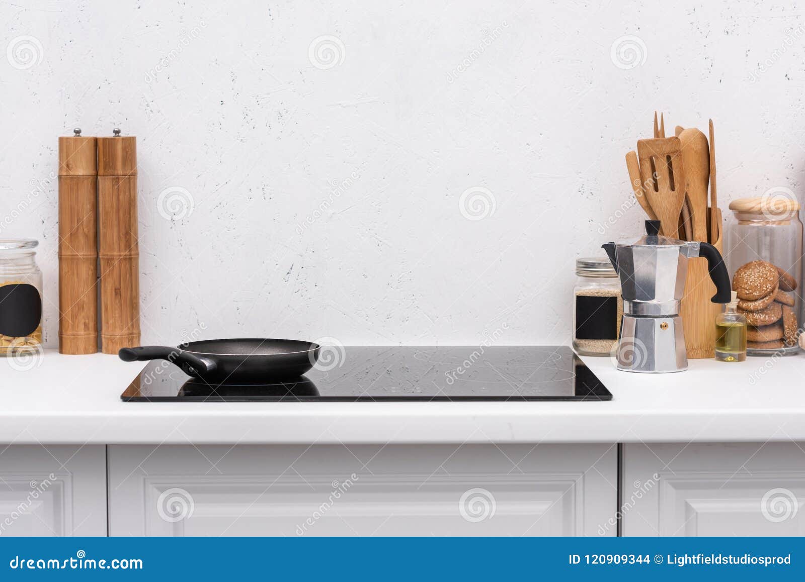 Frying Pan on Induction Panel at Modern Kitchen in Front of Blank Stock ...