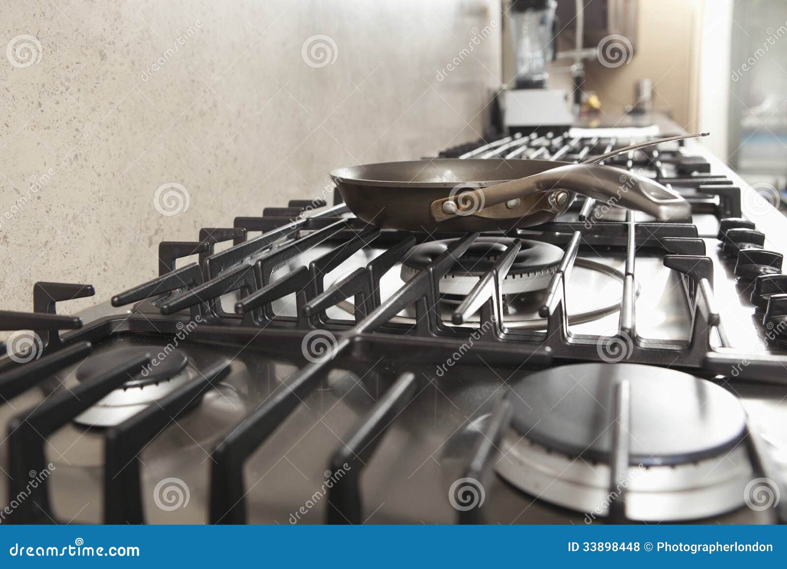 Frying Pan on Stove stock photo. Image of closeup, industry - 33898448