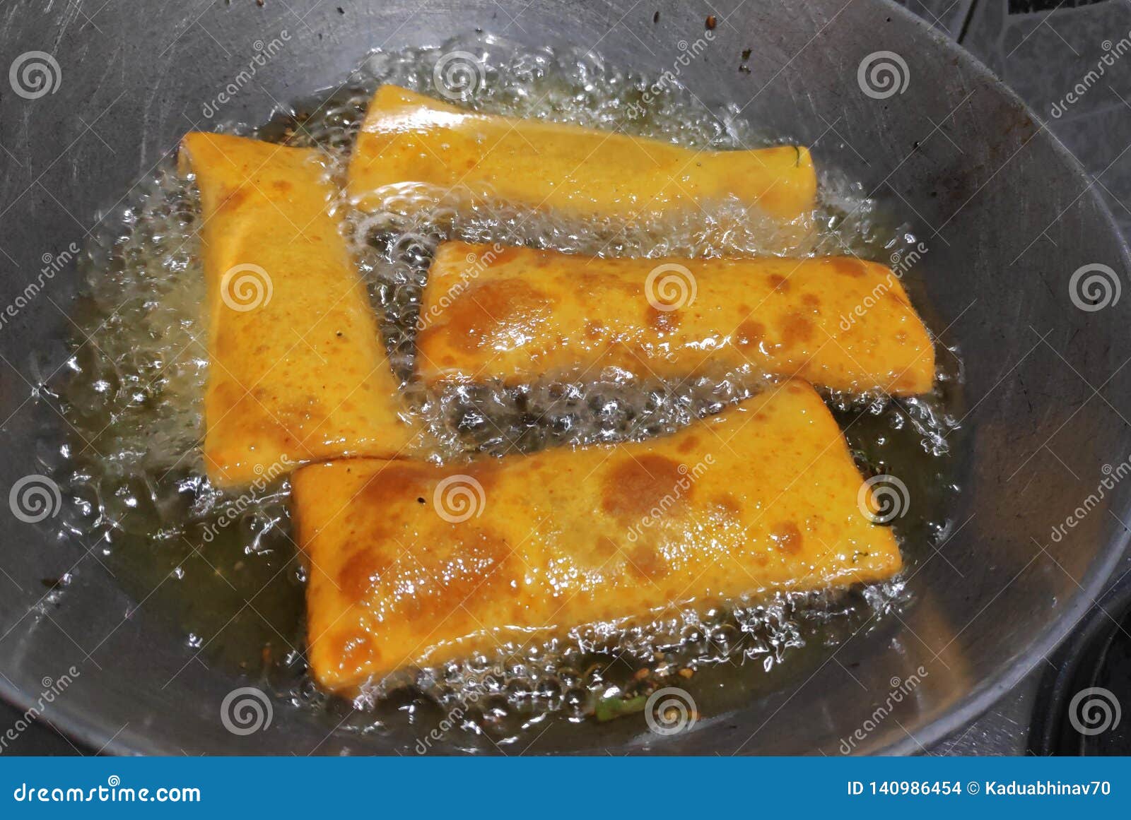 Frying snacks in a pan stock photo. Image of snacks - 140986454