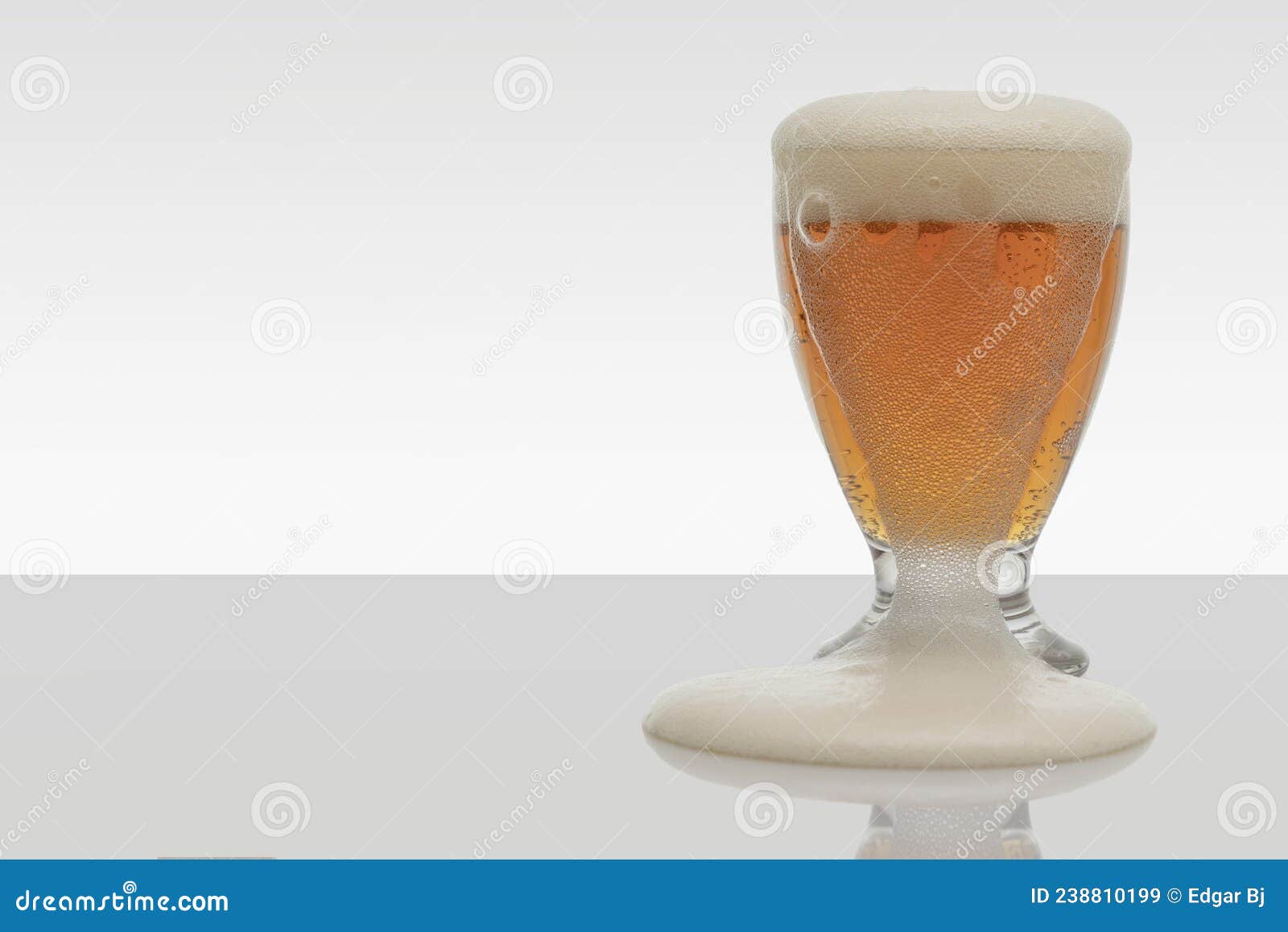 Full Beer Glass and Spilling Foam Down the Side, Copy Space for Text ...
