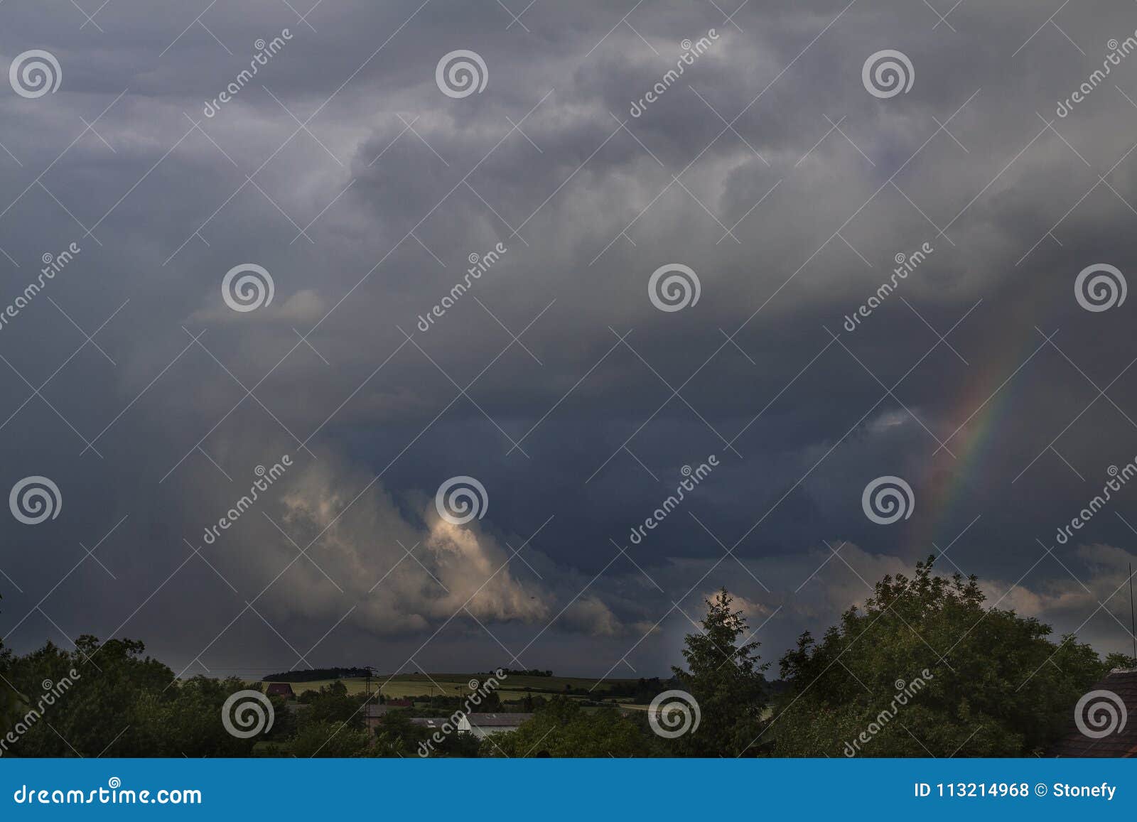 Grey clouds and a rainbow stock photo. Image of illuminated - 113214968