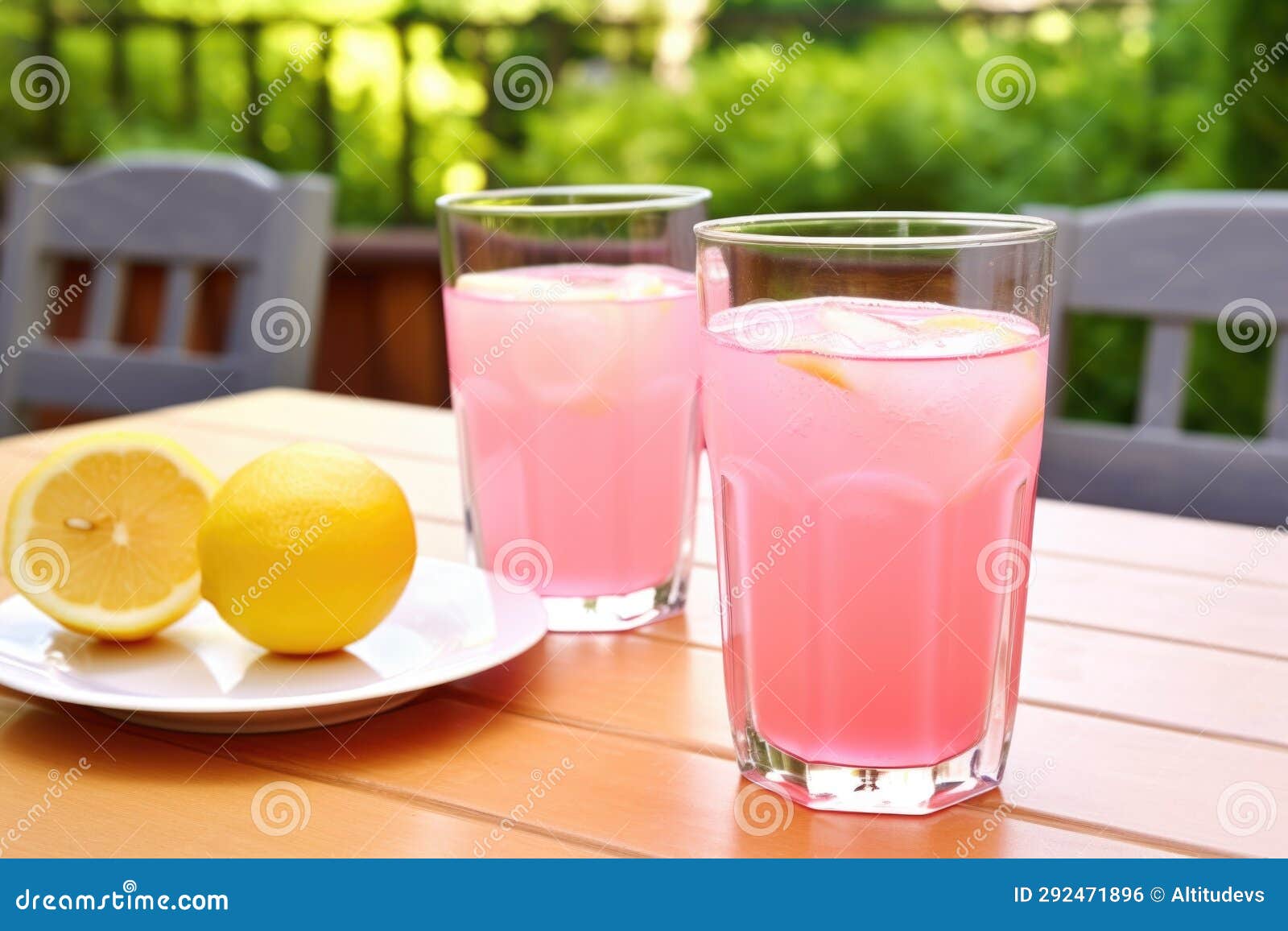 Full and Empty Glasses of Pink Lemonade on a Patio Table Stock Photo ...