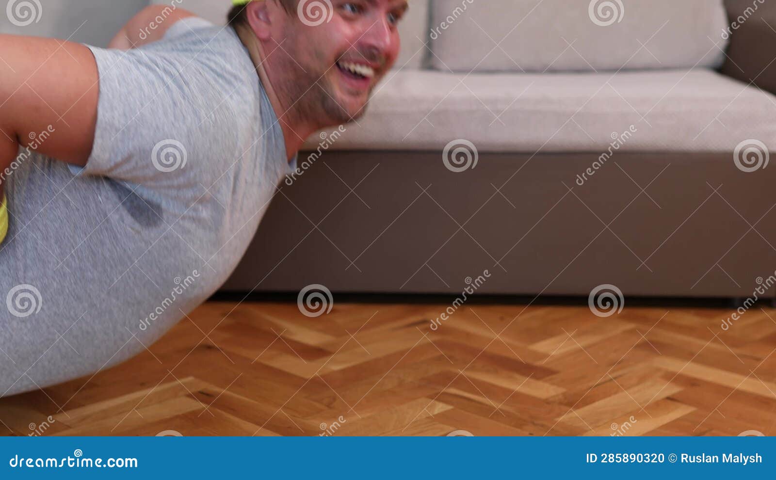 A Full Funny Man in a Sports Uniform Performs Funny Push-ups from the ...