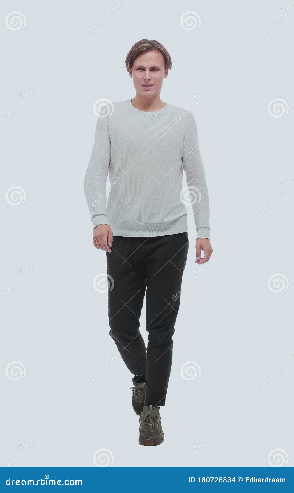 In Full Growth. Confident Young Man Striding Forward Stock Photo ...