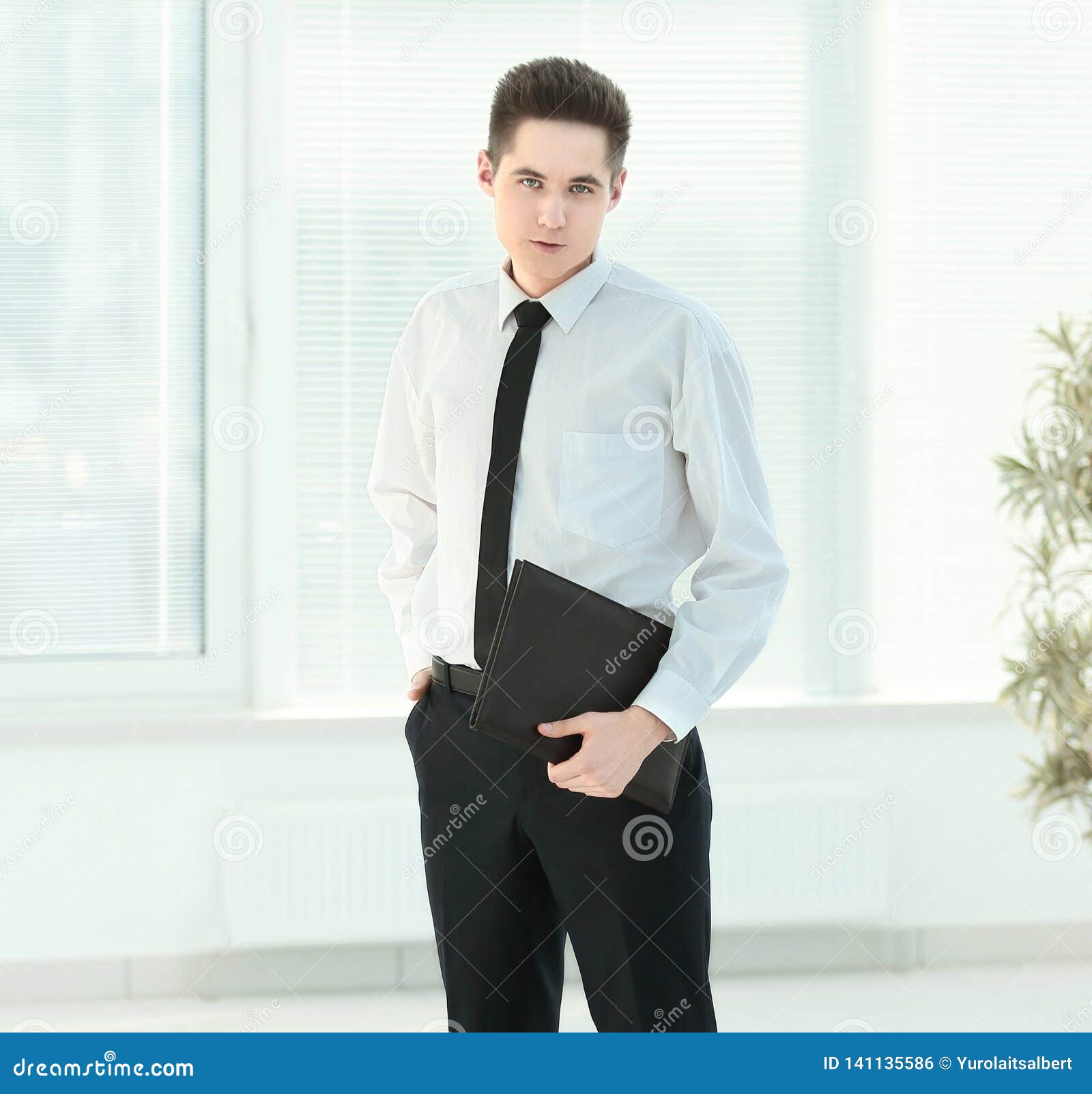 Serious Employee with Documents Standing in the Office Stock Photo ...